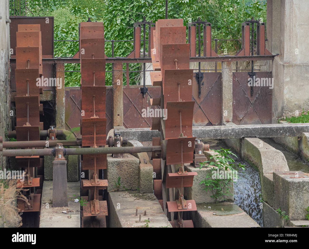 water mill with three wheels that operate the mill Stock Photo - Alamy