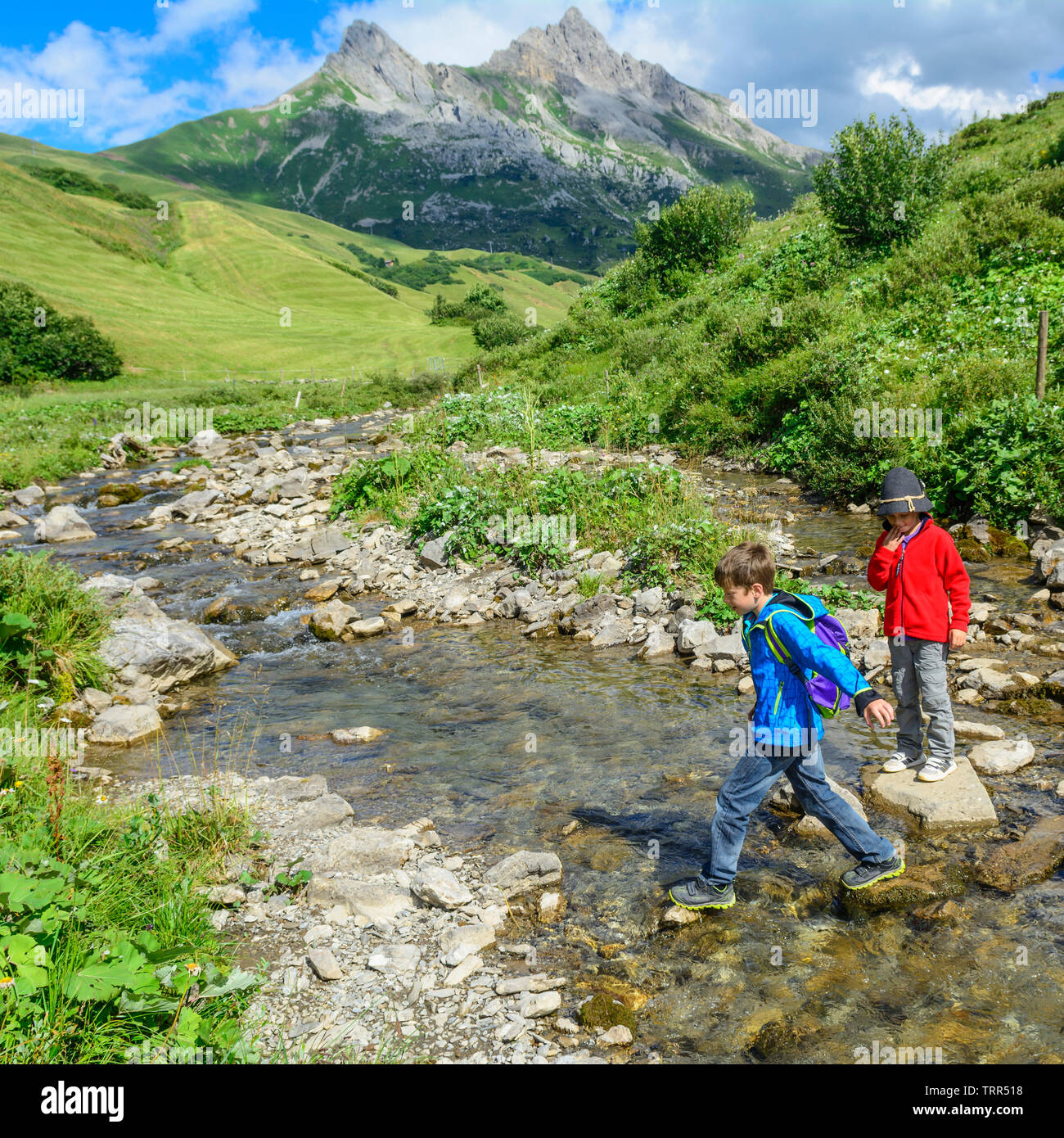 Children hiking in the beautiful nature of the western austrian alps ...