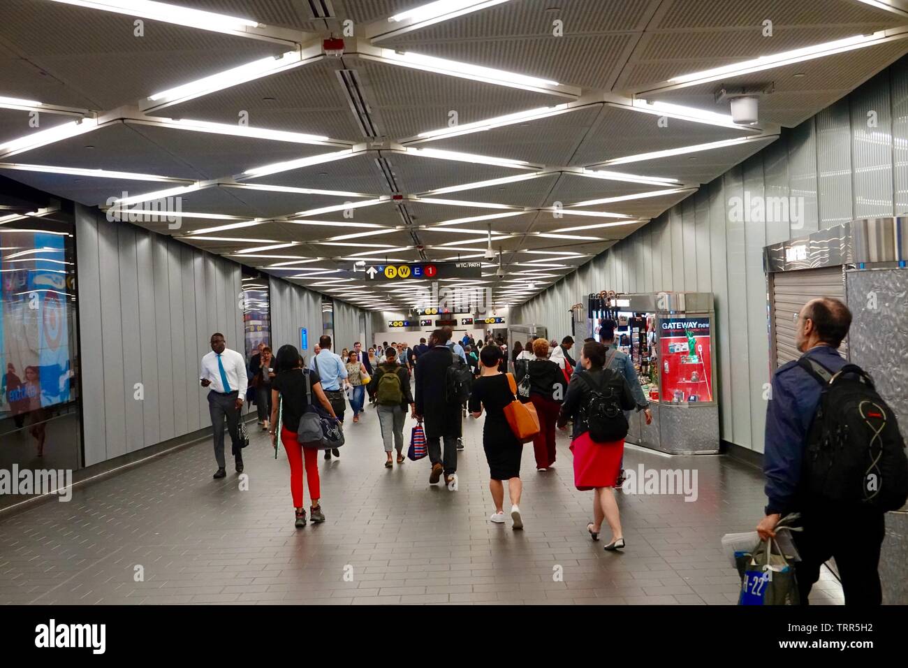 Commuters walking through the underground tunnel from the Fulton Center ...