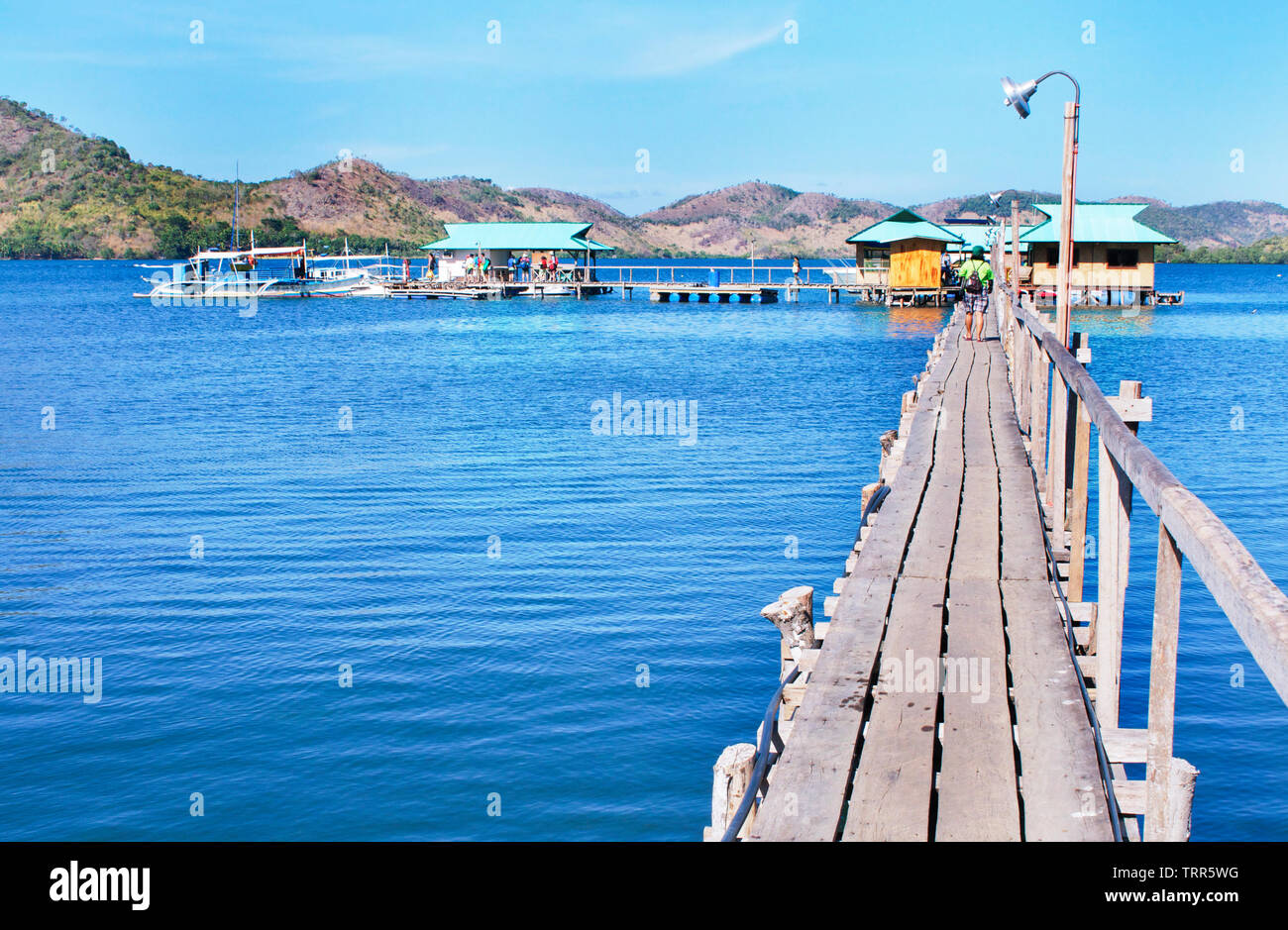 A small pier in Coron serves the need for boats to dock and load and ...