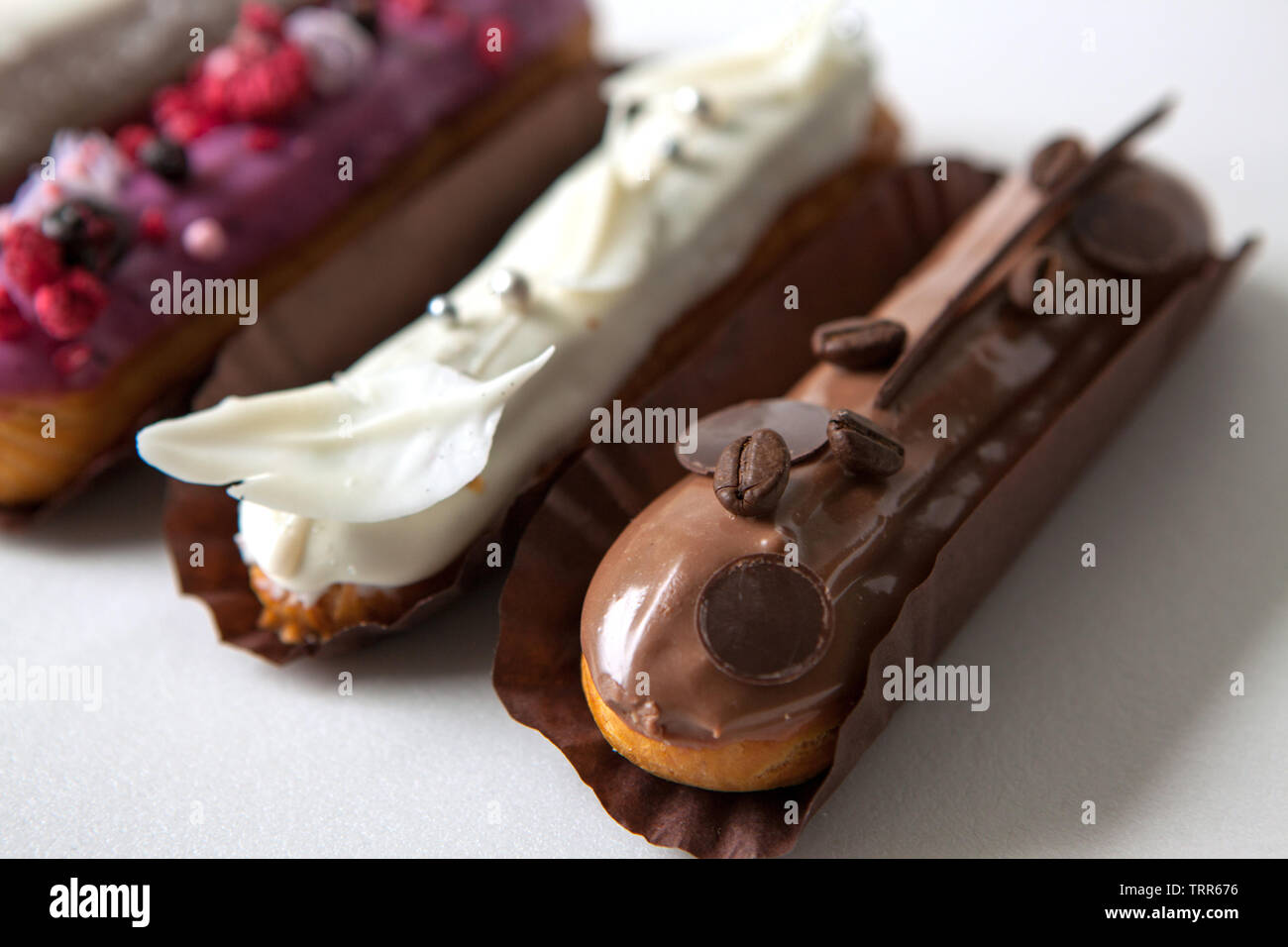 Set of several eclairs with various fillings and design isolate on a ...