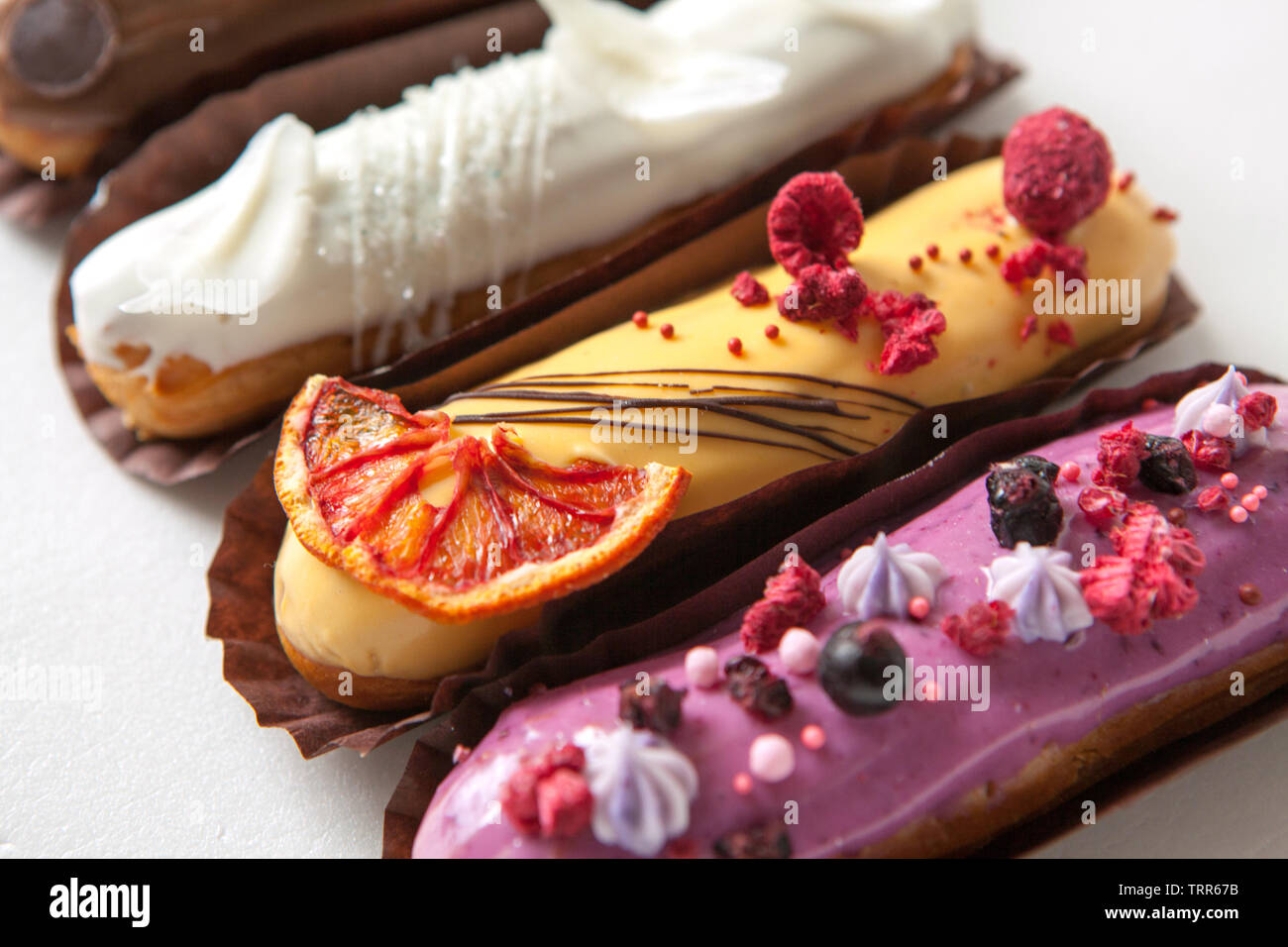 Set of several eclairs with various fillings and design isolate on a ...