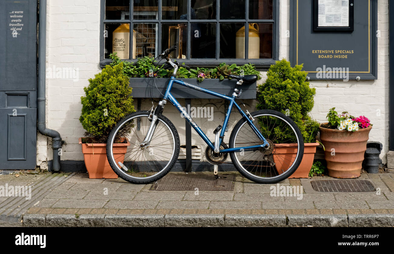Bicycle propped up by window of old coaching inn Stock Photo - Alamy