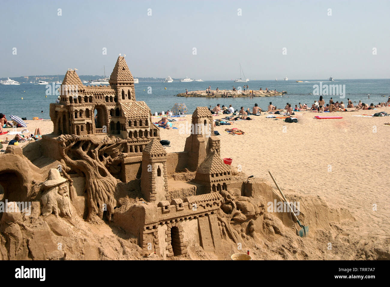 Sand castle and sunbathing people at Cannes Beach in Cannes, France ...