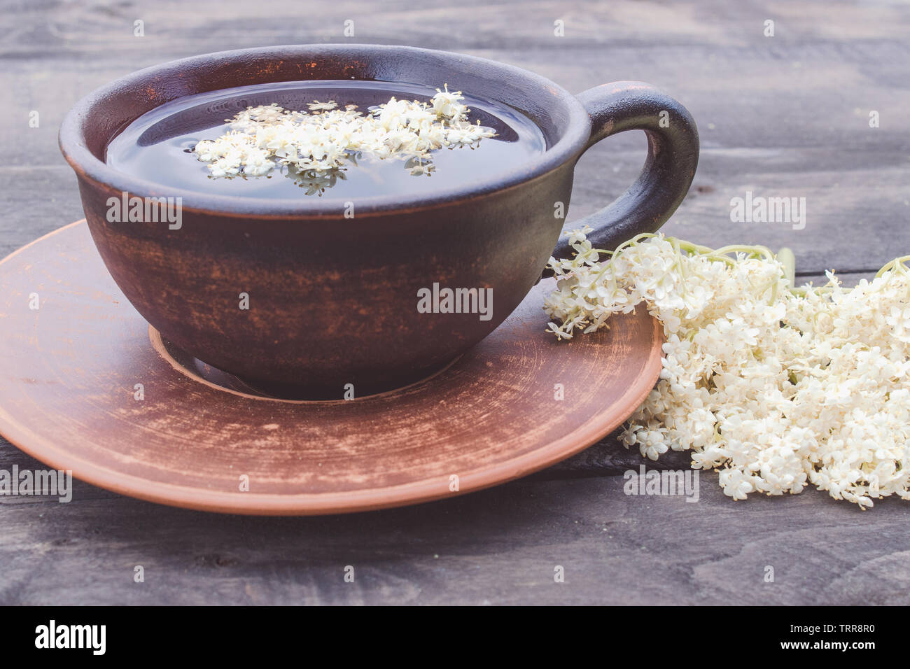 a cup of Elderflower tea with fresh flowers. Healthy Medicine ...