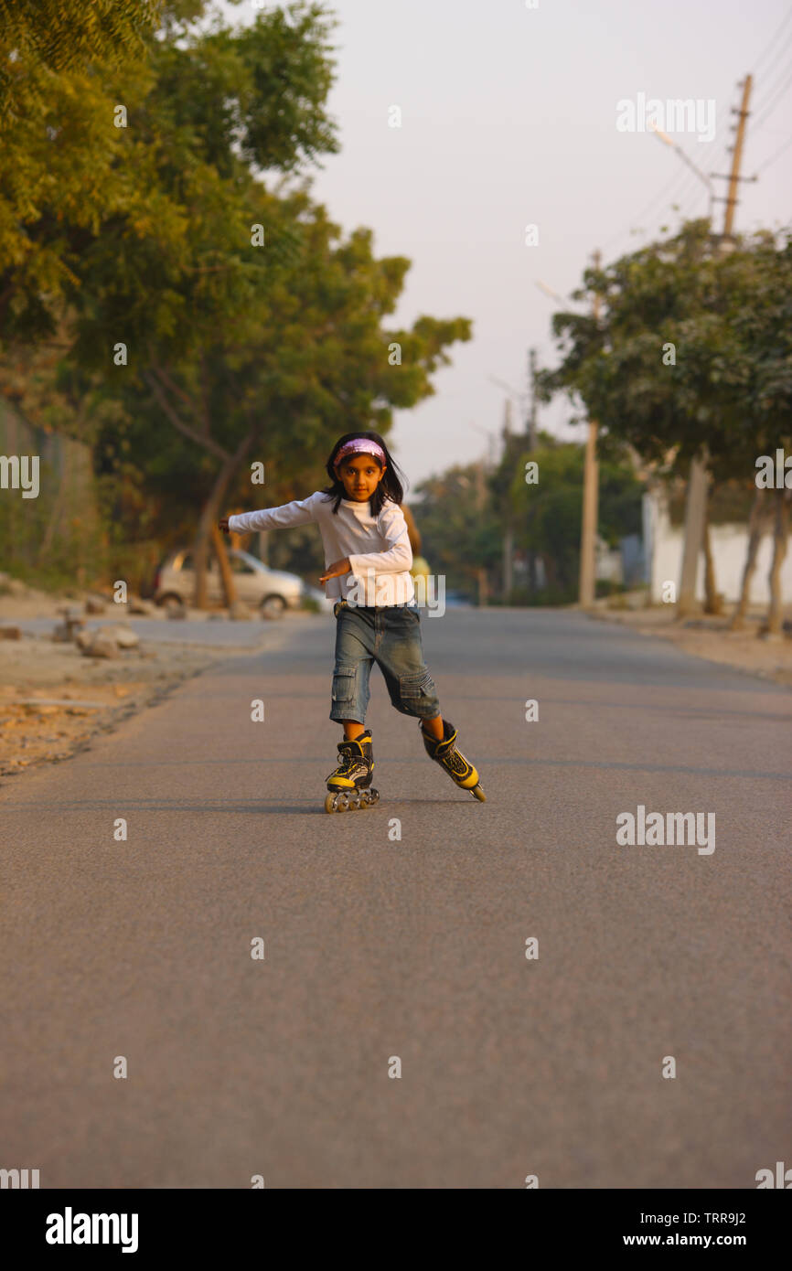 Girl inline skating on the road Stock Photo - Alamy