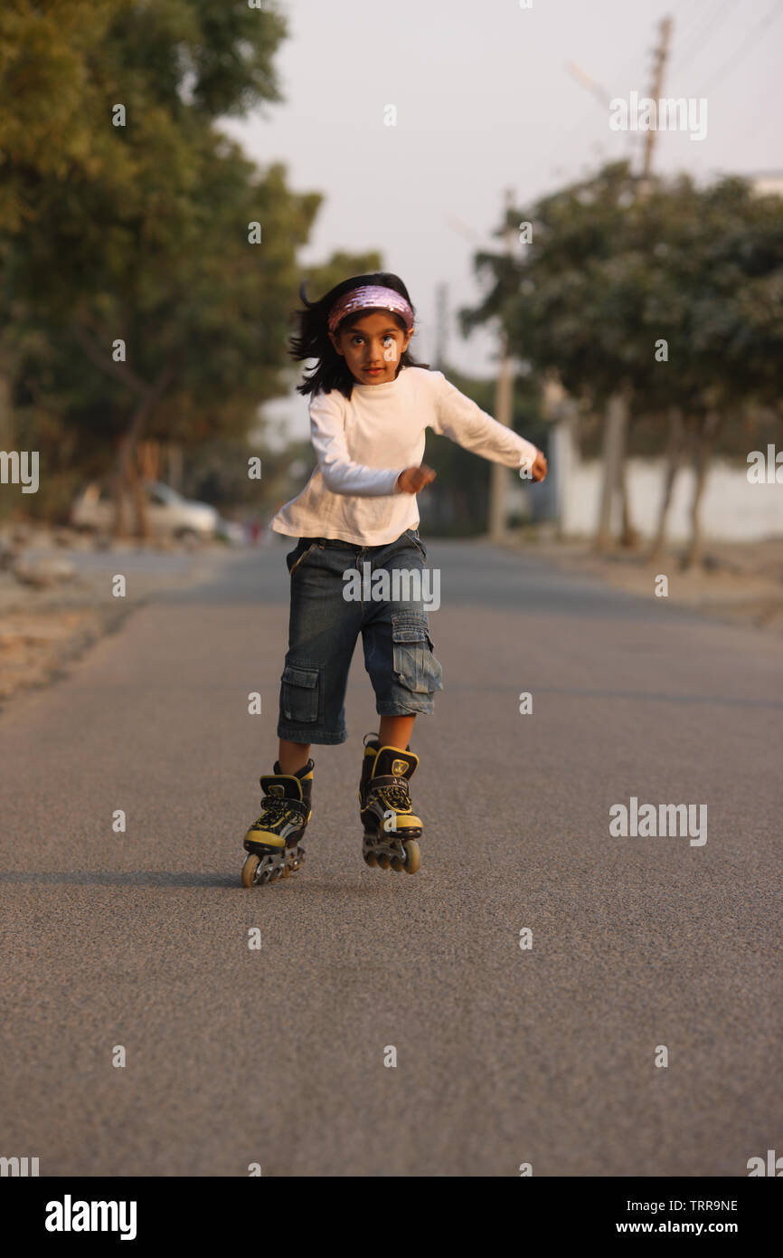 Indian girl inline skating on the road Stock Photo - Alamy