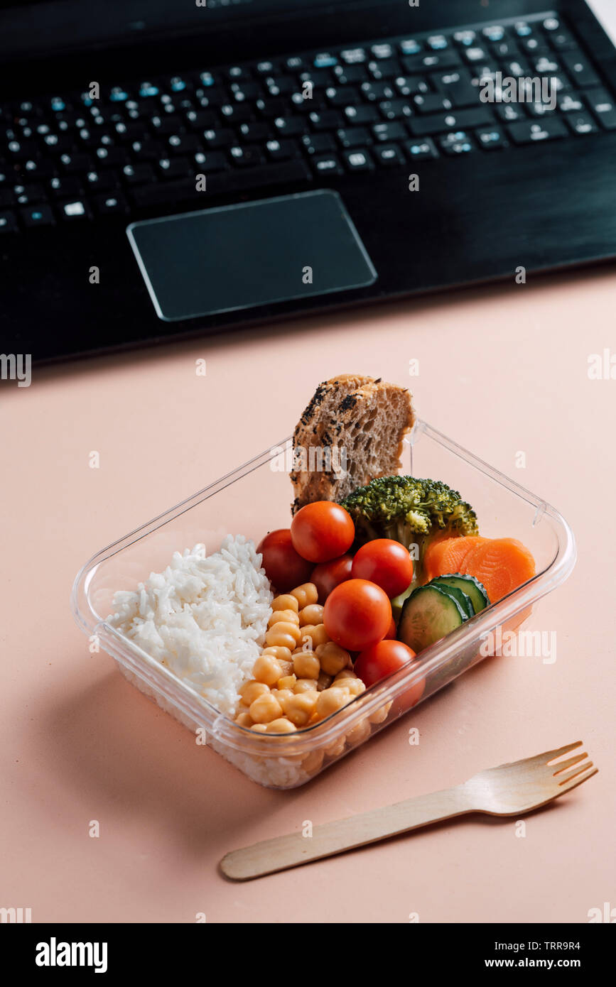 Healthy food in lunch box, on working table with laptop .eating at ...