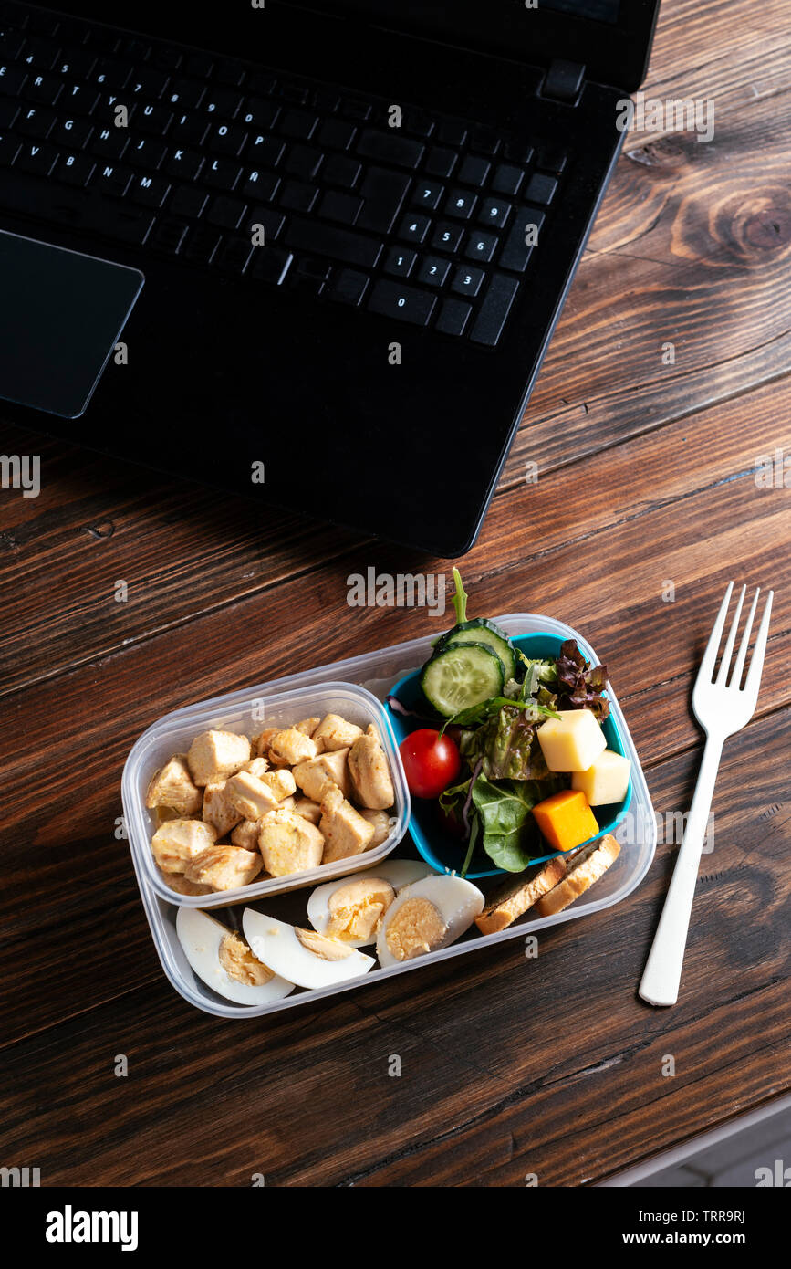 Healthy food in lunch box, on working table with laptop .eating at ...