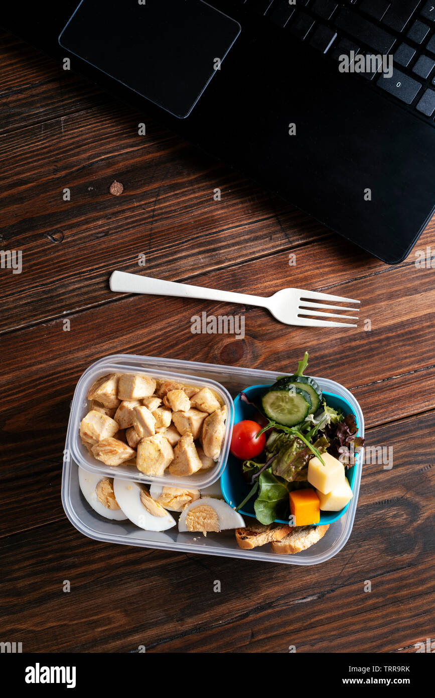 Healthy food in lunch box, on working table with laptop .eating at ...