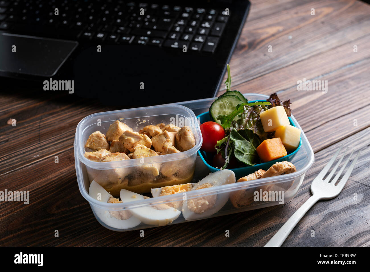 Healthy food in lunch box, on working table with laptop .eating at ...