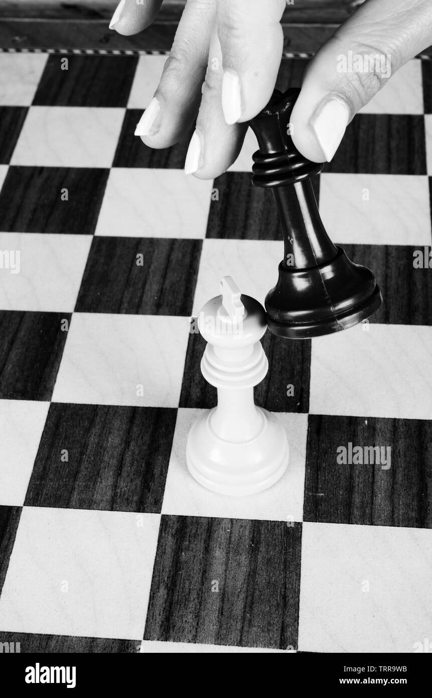 Female hand carrying a chess queen against the king, a concept Stock ...