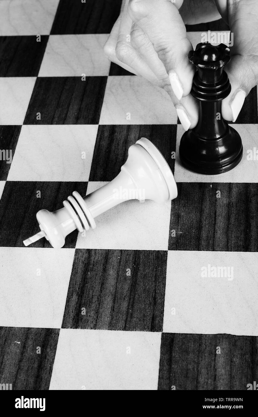 Female hand carrying a chess queen against the king, a concept Stock ...