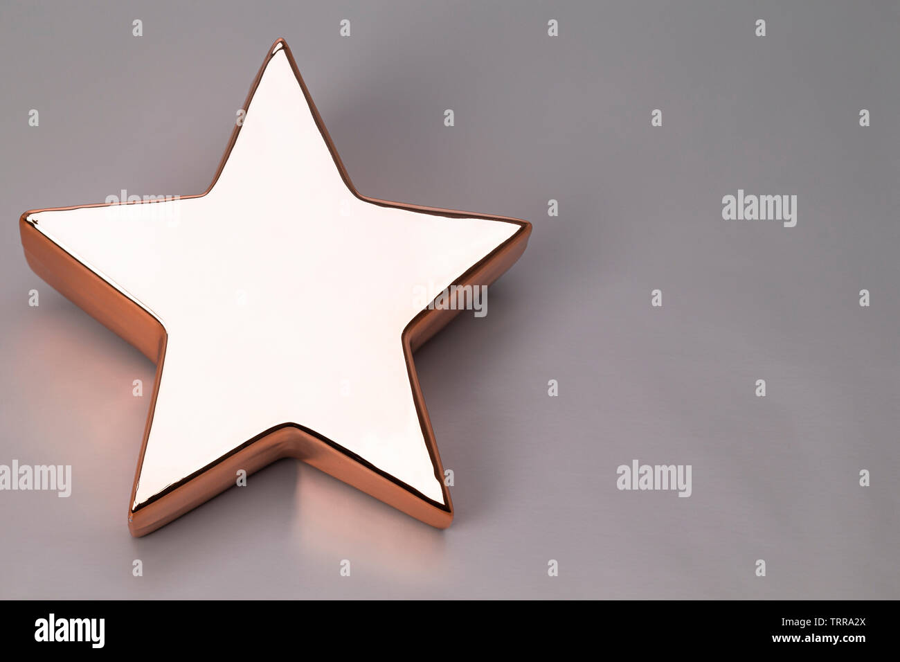 Image shows an golden x-mas star, isolated on grey background with ...