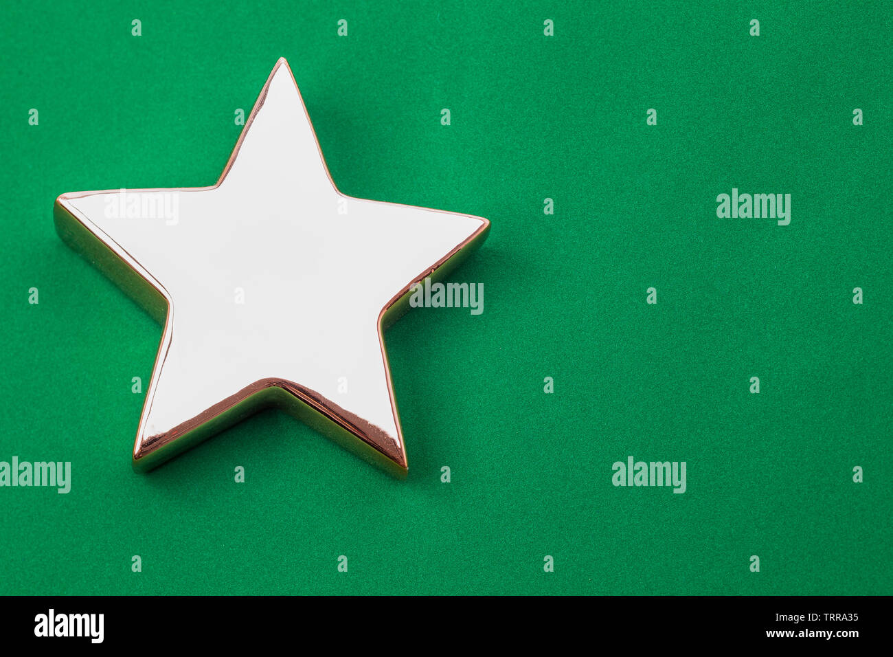 Image shows an golden x-mas star, isolated on green background with ...