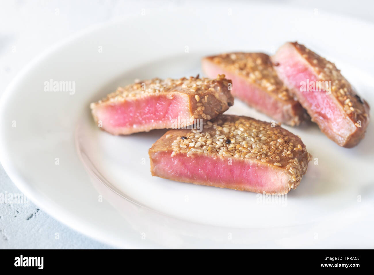 Fried tuna in sesame seeds on the white plate: cross section Stock ...