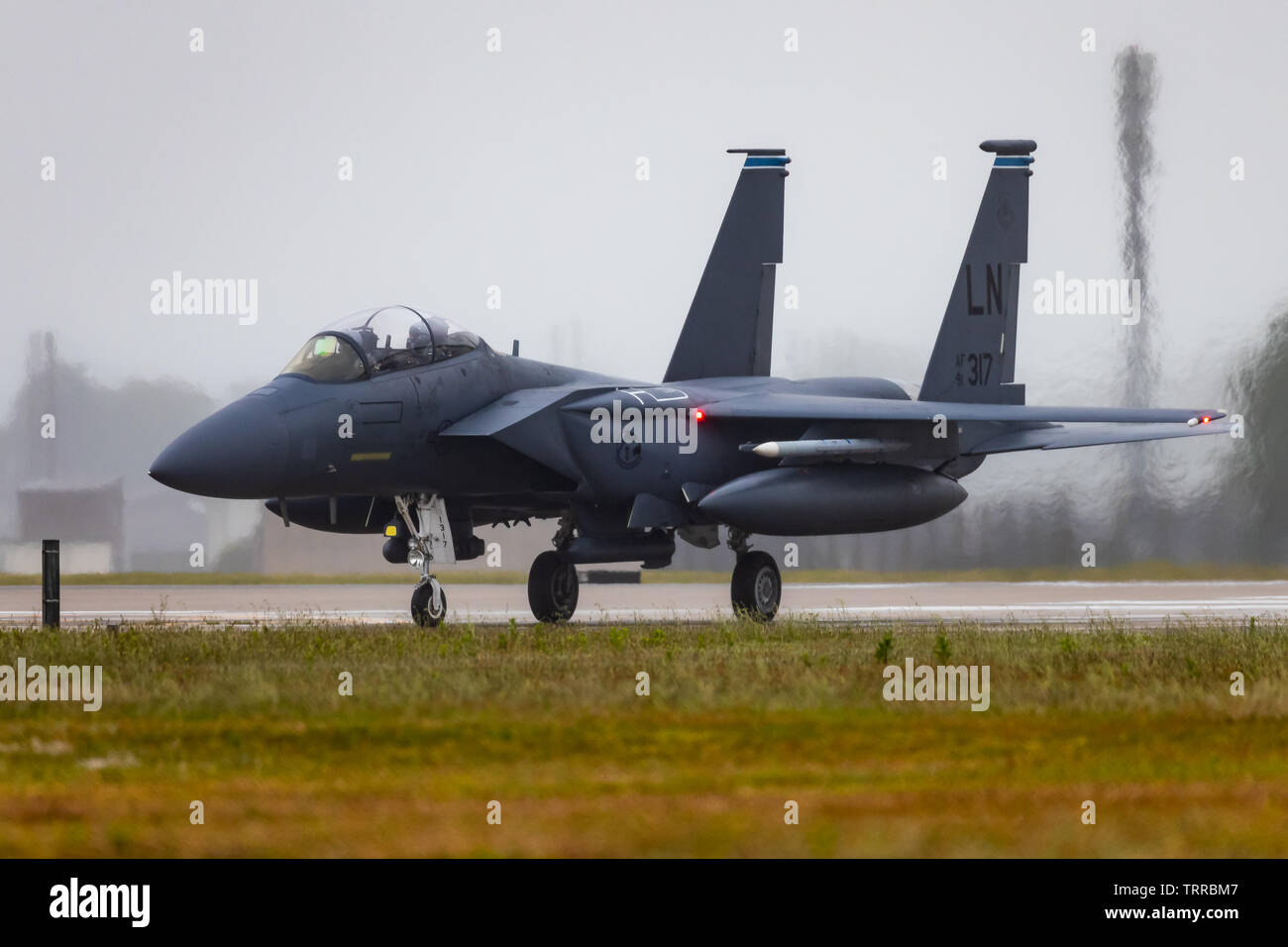 A USAF F-15 taxis at the end of the runway at RAF Lakenheath, Suffolk ...