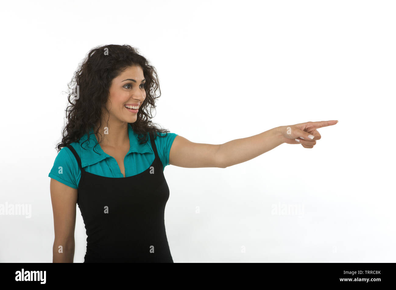 Woman pointing and smiling Stock Photo - Alamy