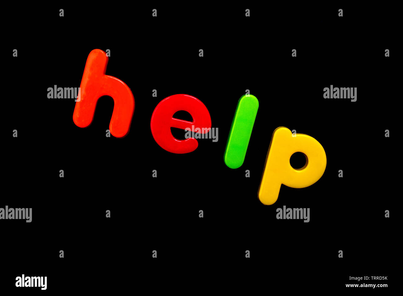 The word HELP spelt with brightly coloured letters over a black ...