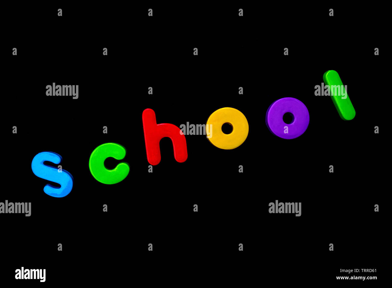The word SCHOOL spelt with brightly coloured letters over a black ...