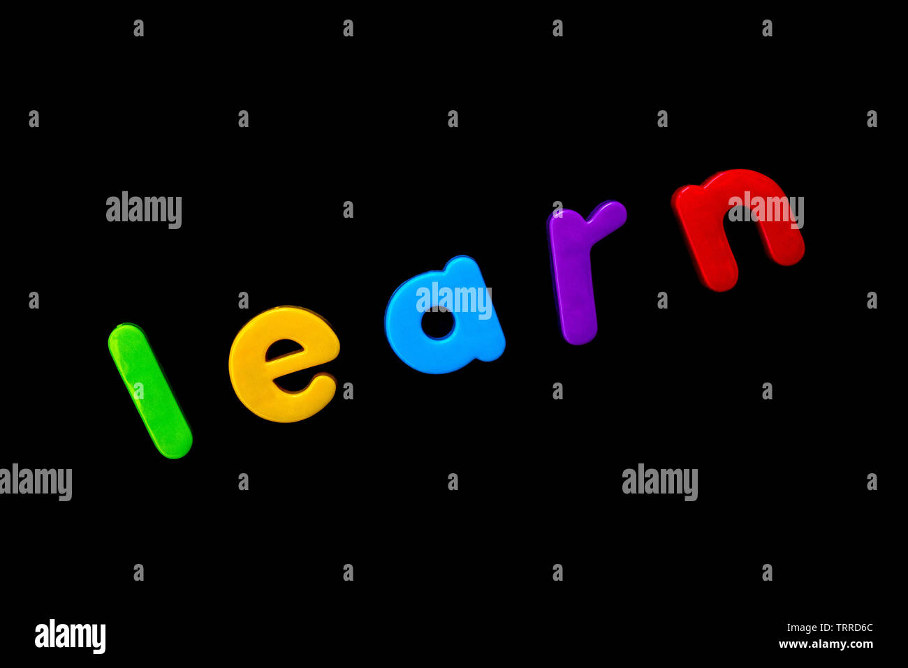 The word LEARN spelt with brightly coloured letters over a black ...