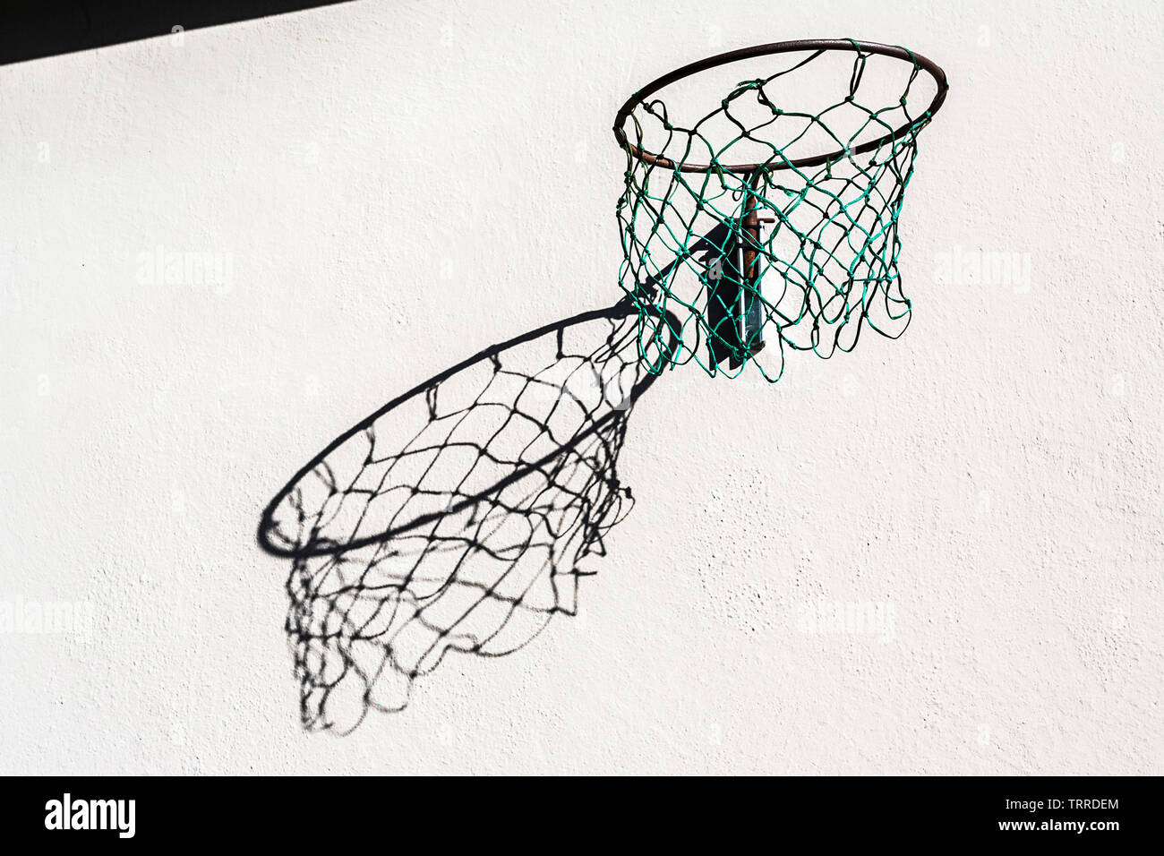 Abstract view of a hoop and net casting a large distorted shadow on a ...