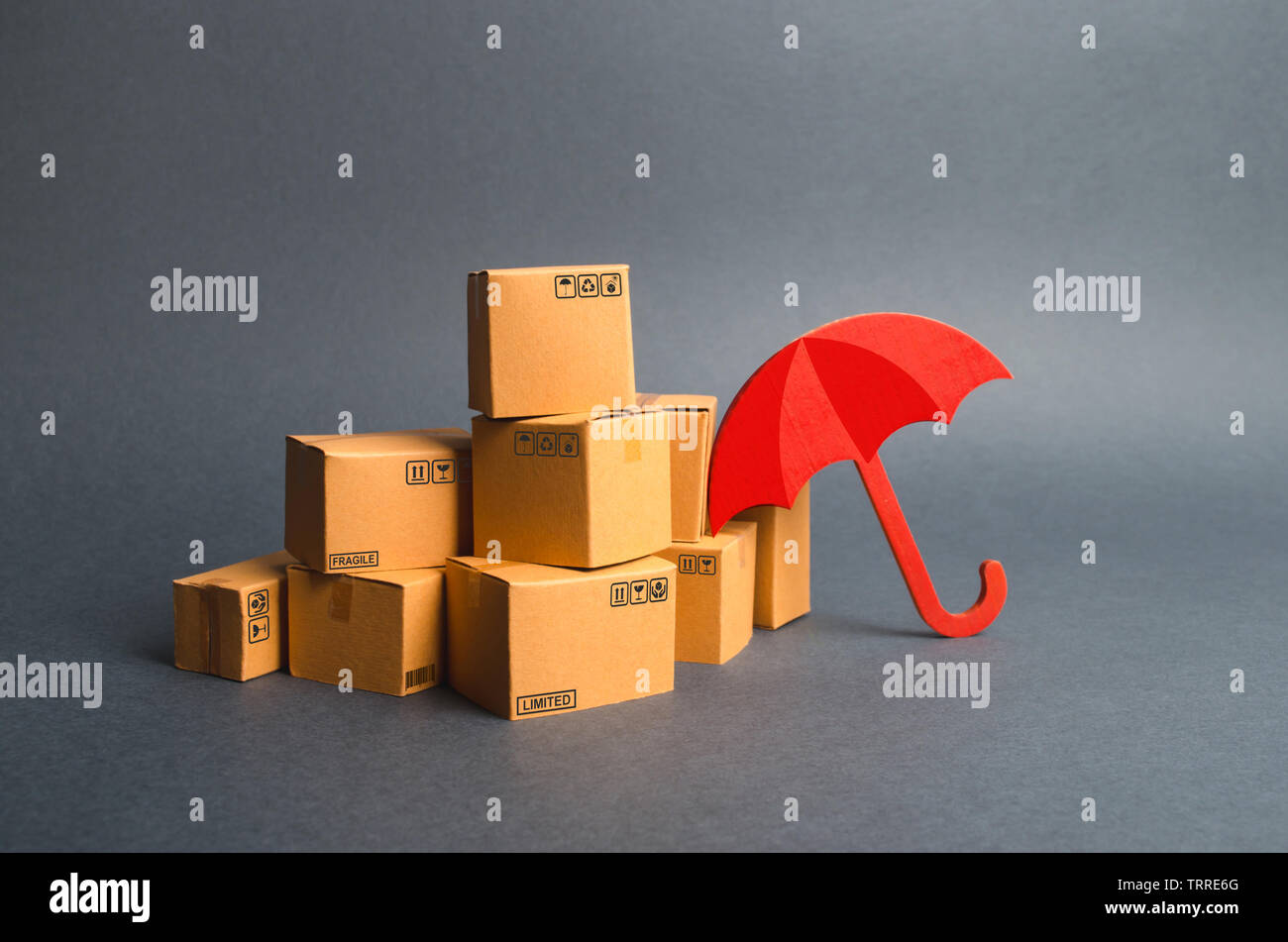 A bunch of cardboard boxes and a red umbrella. concept of insurance ...