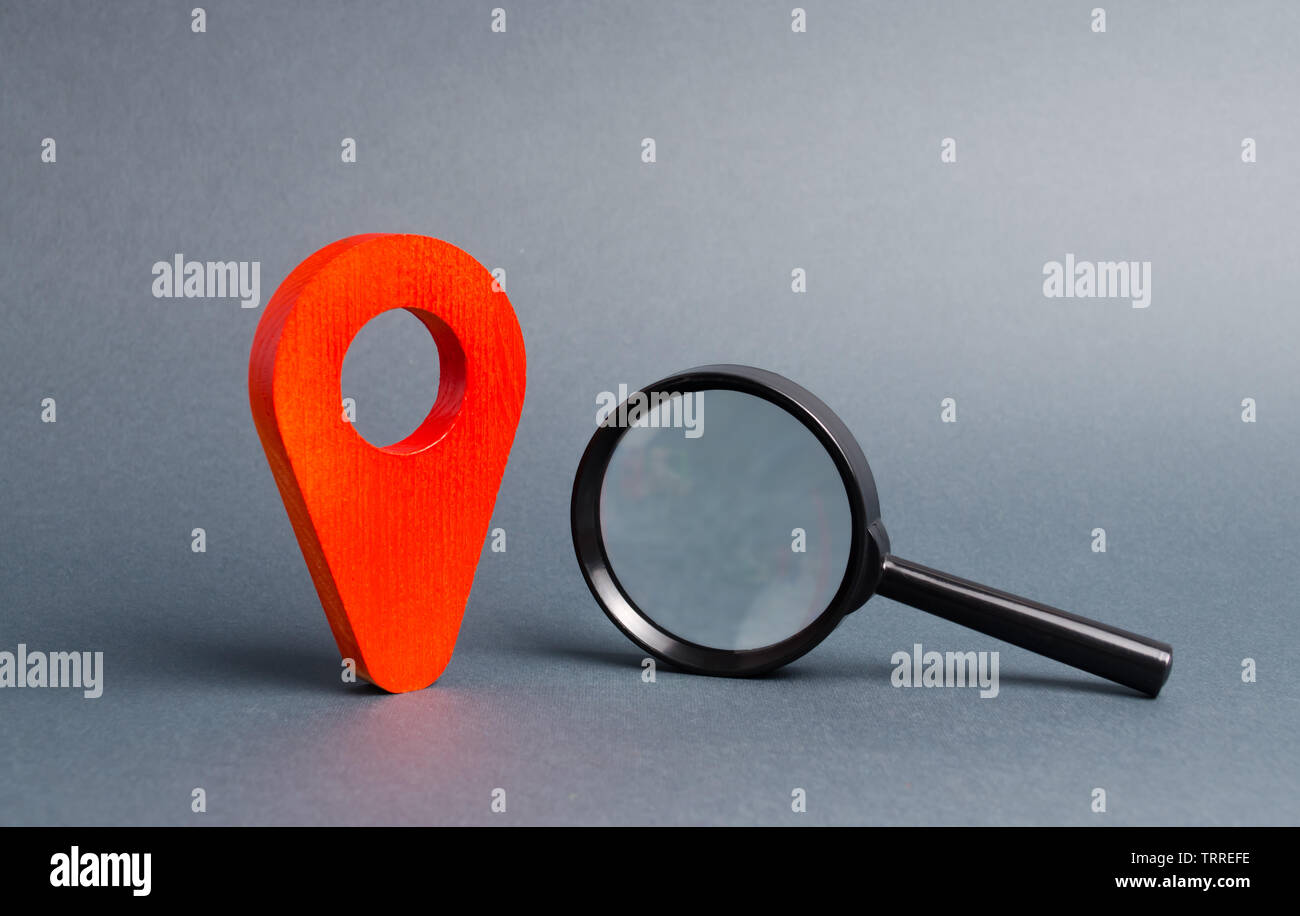 Red location pointer and a Magnifying glass on a gray background ...