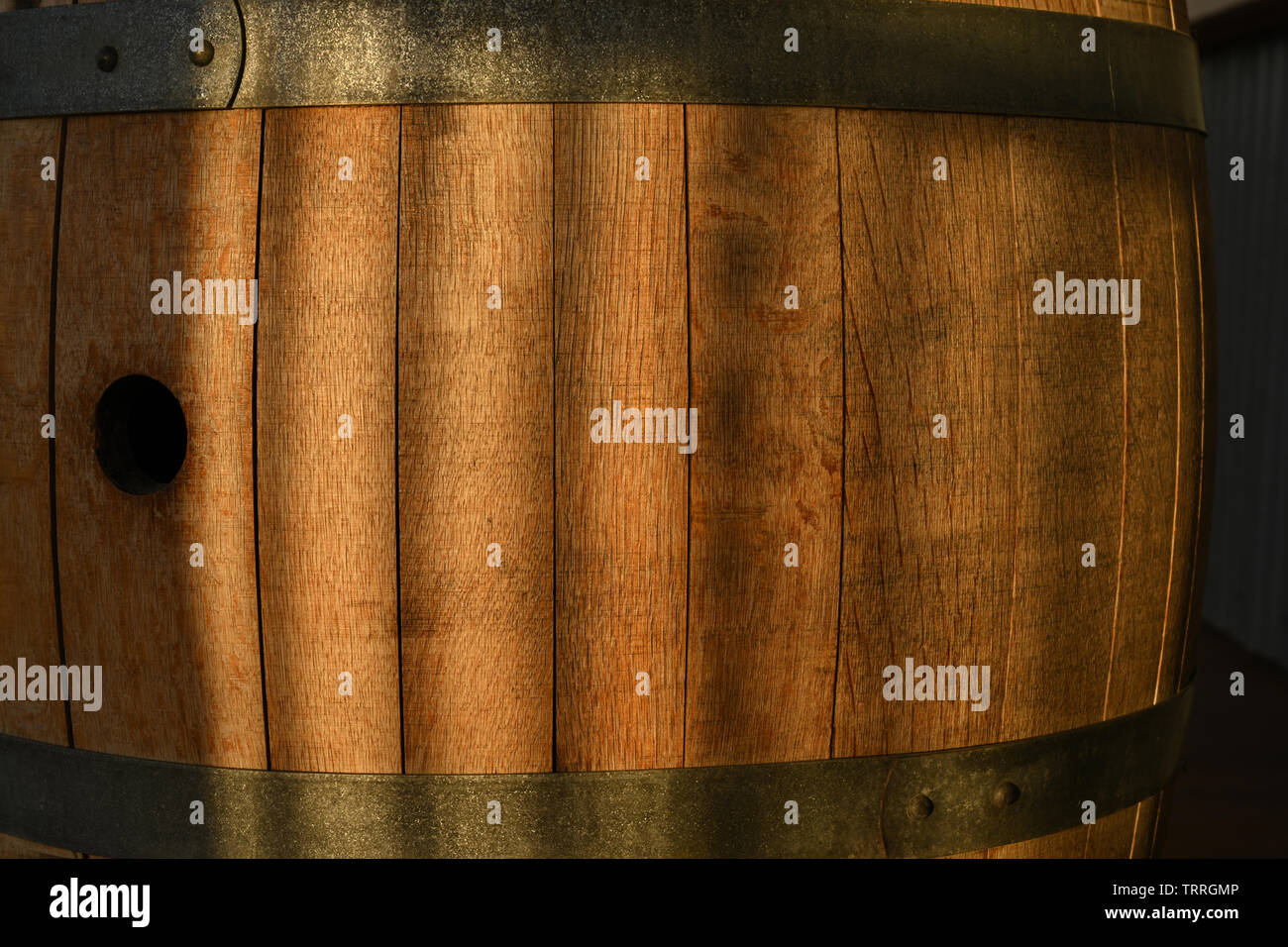 Clos-up-detail old wine barrel with late afternoon light and shadows ...