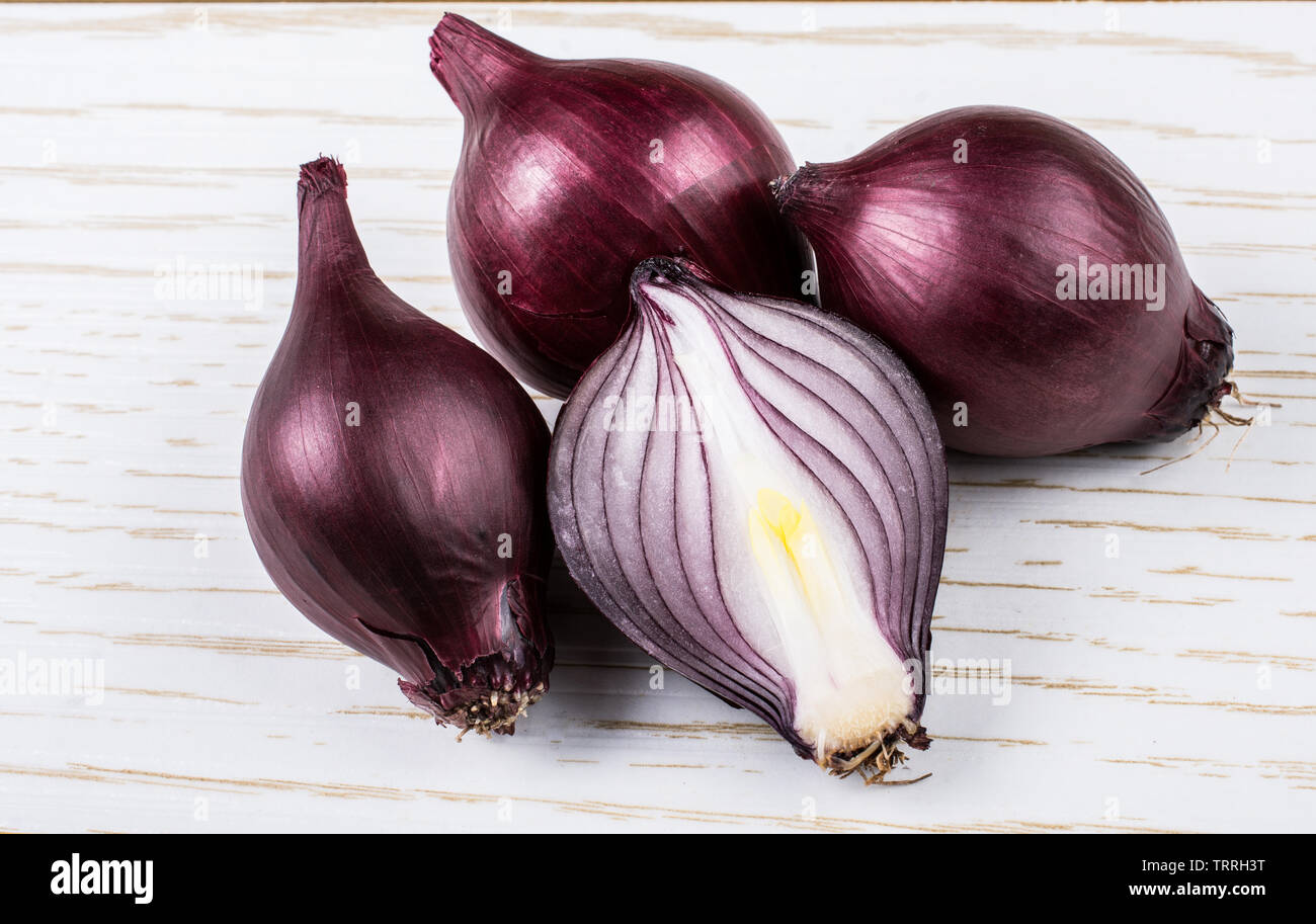 Red onion bulb cut in half on a certain background Stock Photo - Alamy