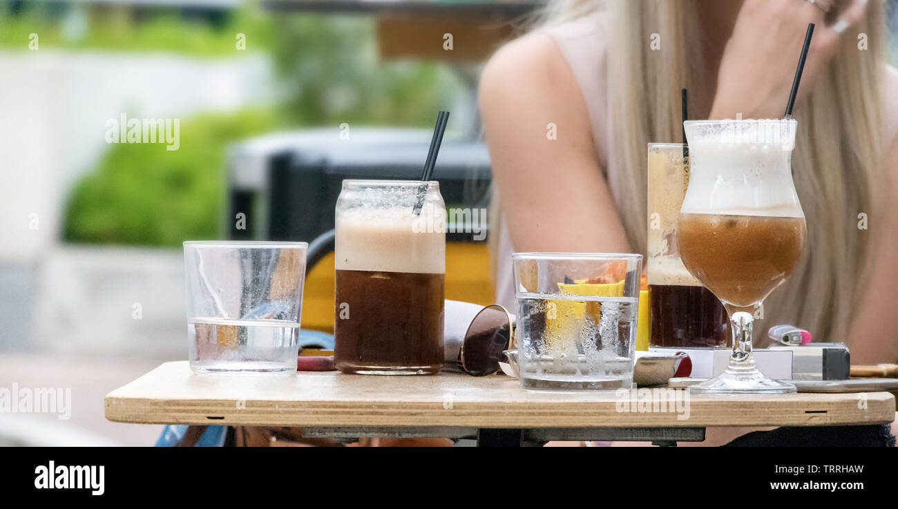 Cold coffee - freddo cappuccino and espresso on a table outdoors at a ...