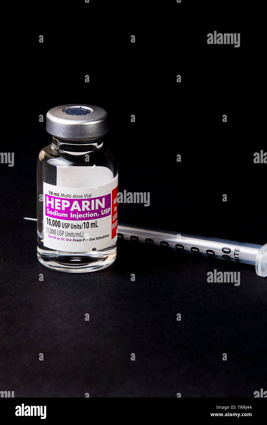 A bottle of the anticoagulant drug Heparin Sodium with a Syringe on a ...