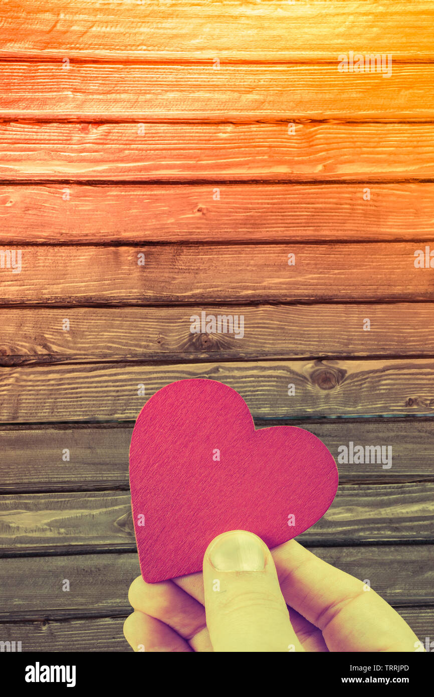 Red heart shaped object in hand as love concept Stock Photo - Alamy