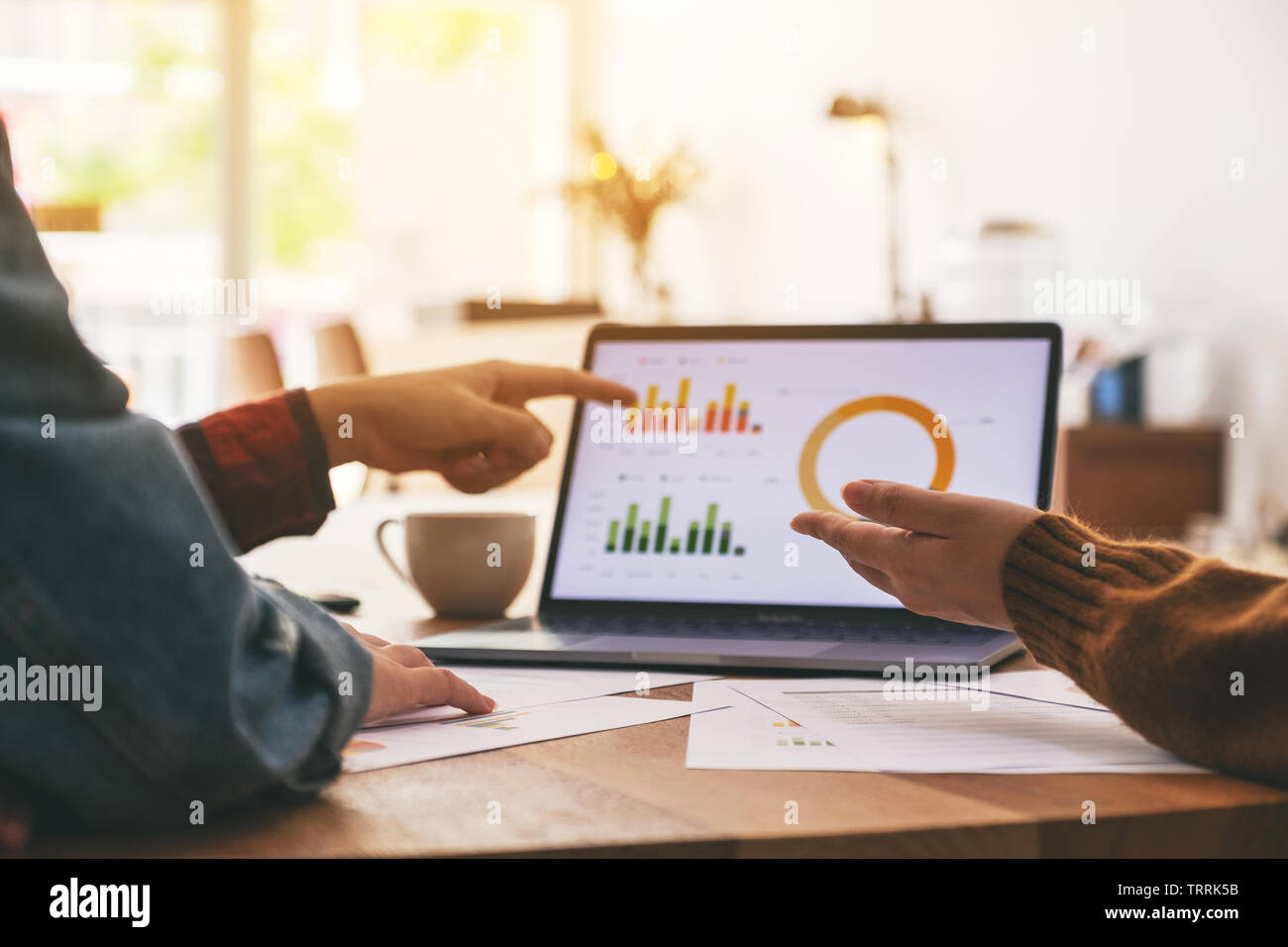 Three businessman using laptop computer while working and discussing ...
