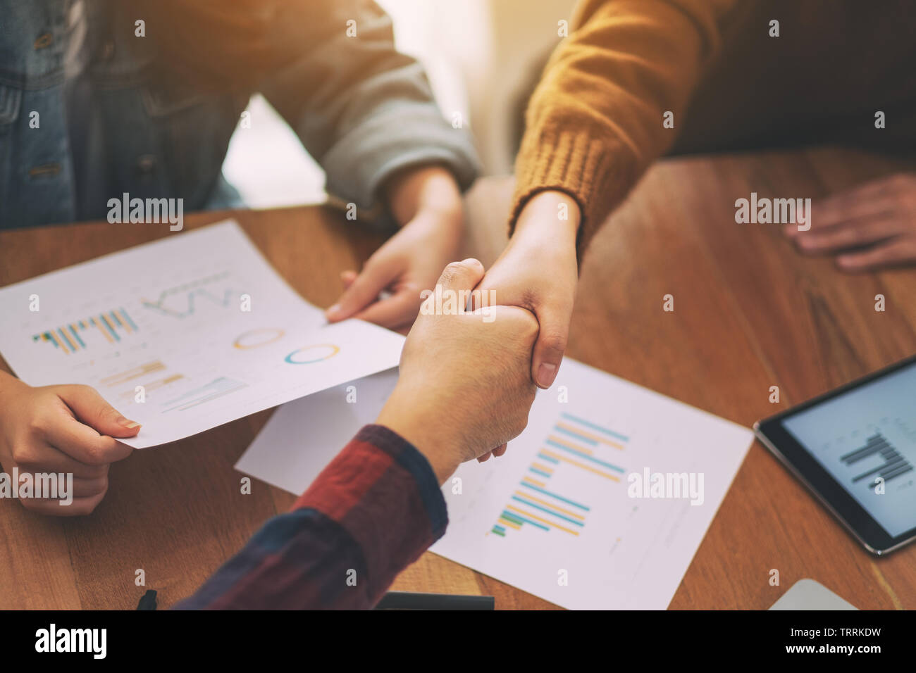 Closeup image of two people shaking hands in a meeting Stock Photo - Alamy