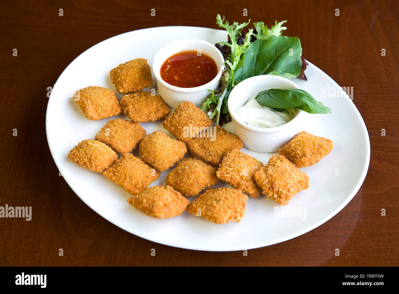 Chicken nuggets with rice and sauce Stock Photo - Alamy