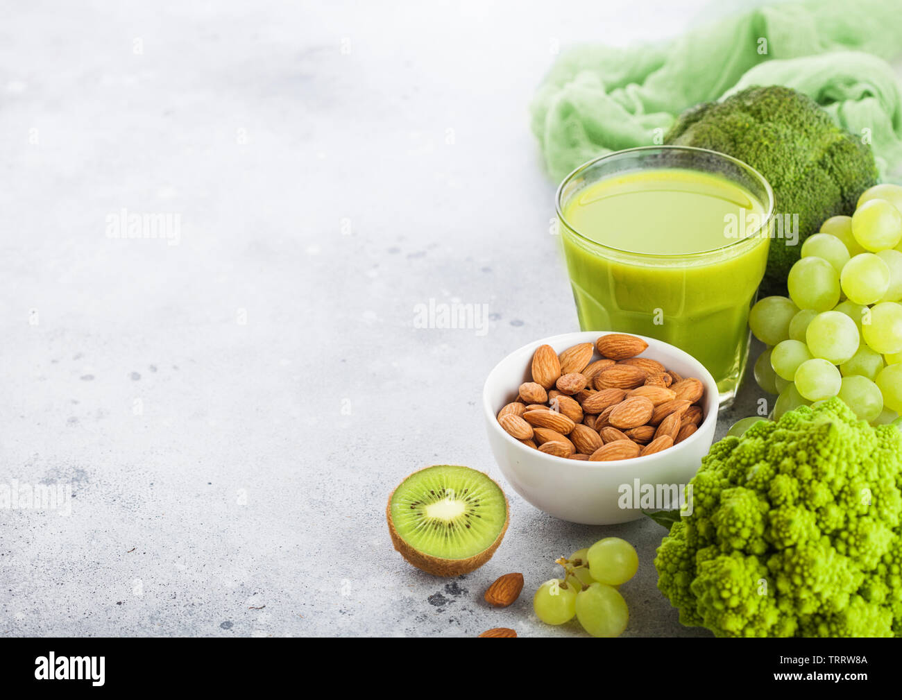 Glass of fresh smoothie juice organic green toned fruit and vegetables ...