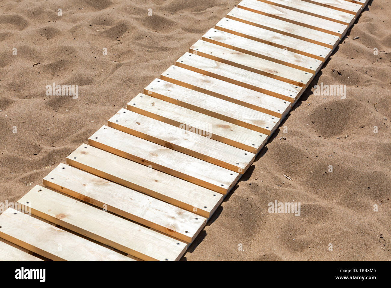 Small wooden bridge on the sand beach Stock Photo - Alamy