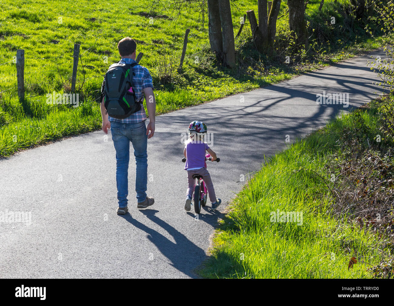 Father and daughter on country lane Stock Photo - Alamy