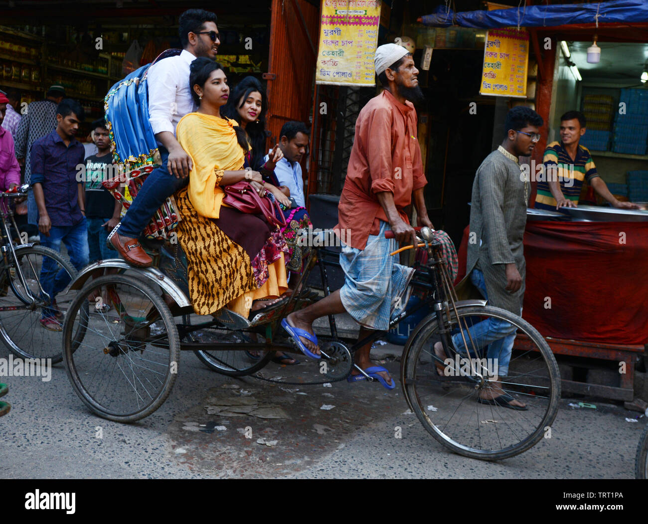Students riding a cycle rickshaw in old Dhaka Stock Photo - Alamy