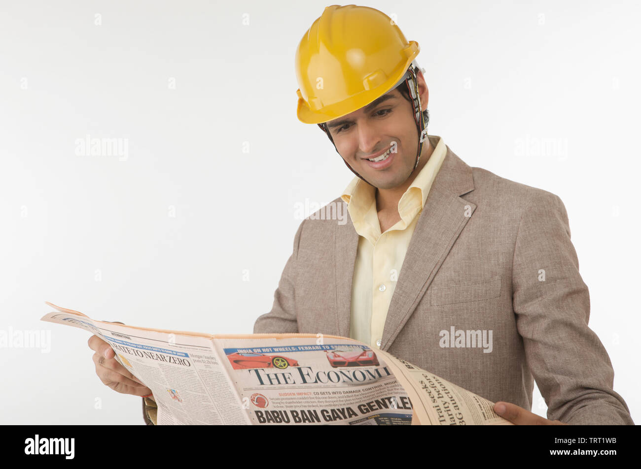Indian male construction worker reading a newspaper Stock Photo - Alamy