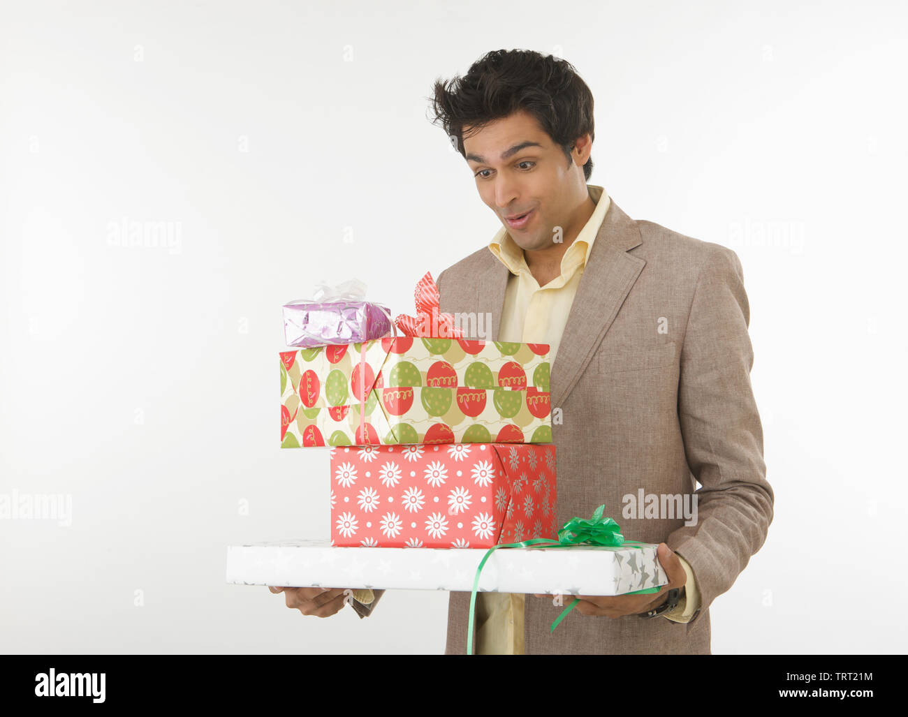 Man holding a stack of gifts Stock Photo - Alamy