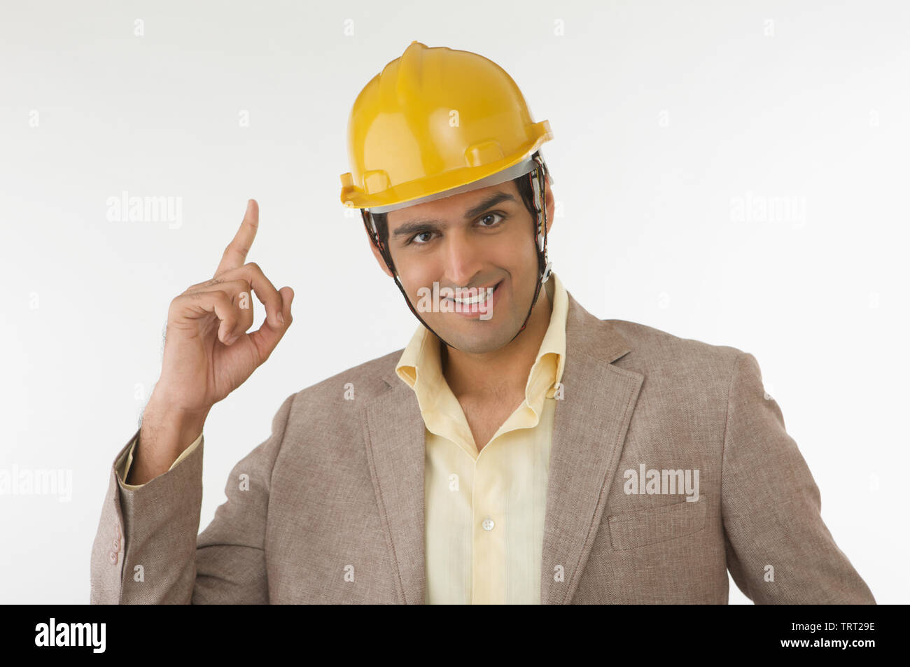Portrait of a male construction worker pointing upward Stock Photo - Alamy