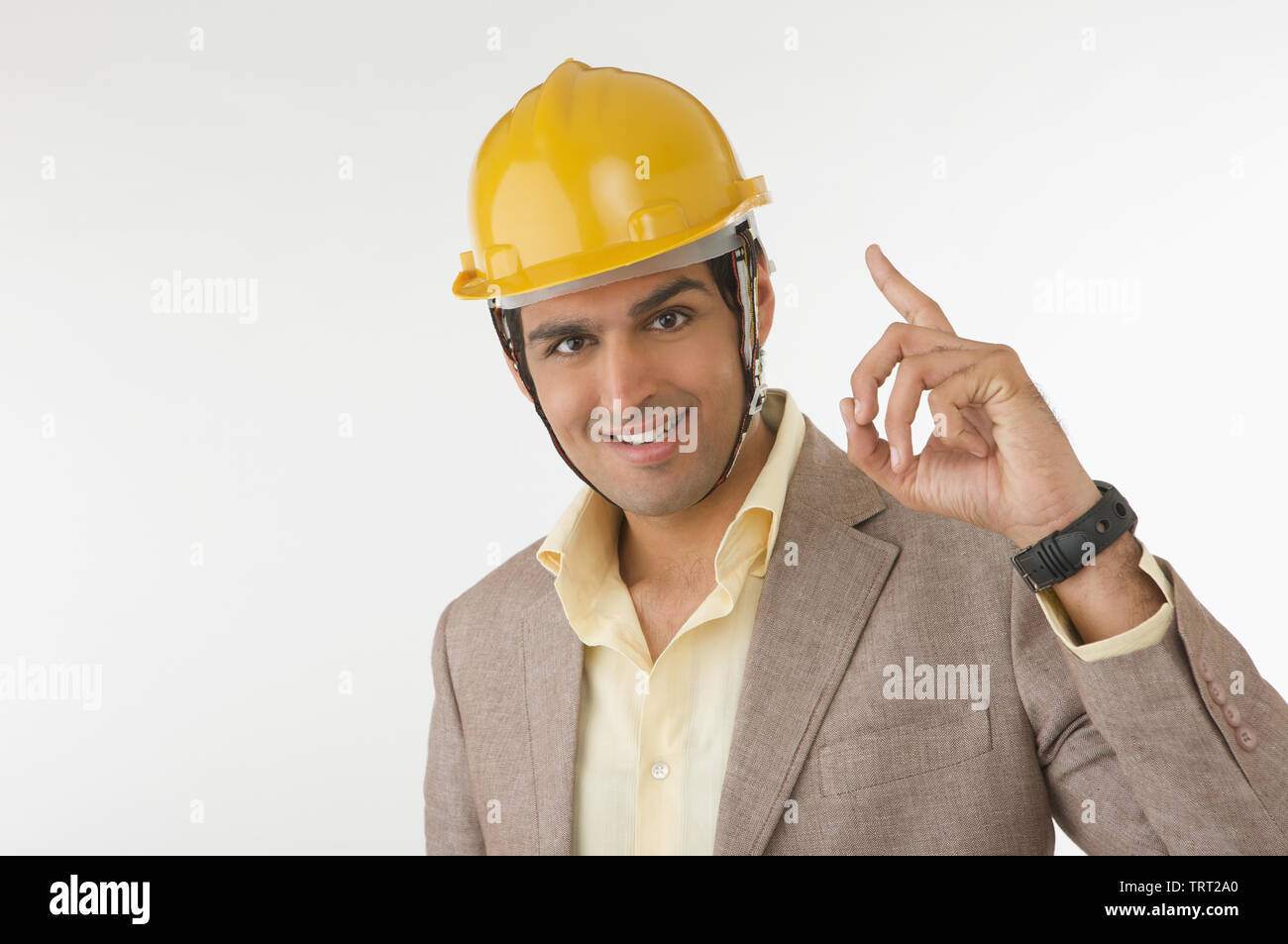 Portrait of a male construction worker pointing upward Stock Photo - Alamy