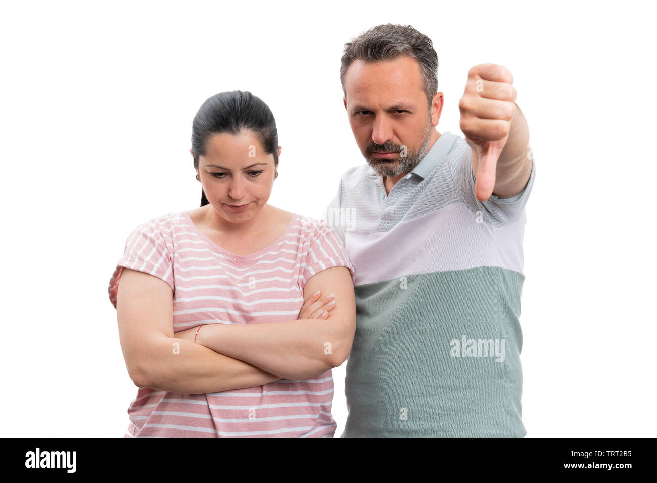 Man showing thumb-down as dislike gesture to upset woman with crossed ...