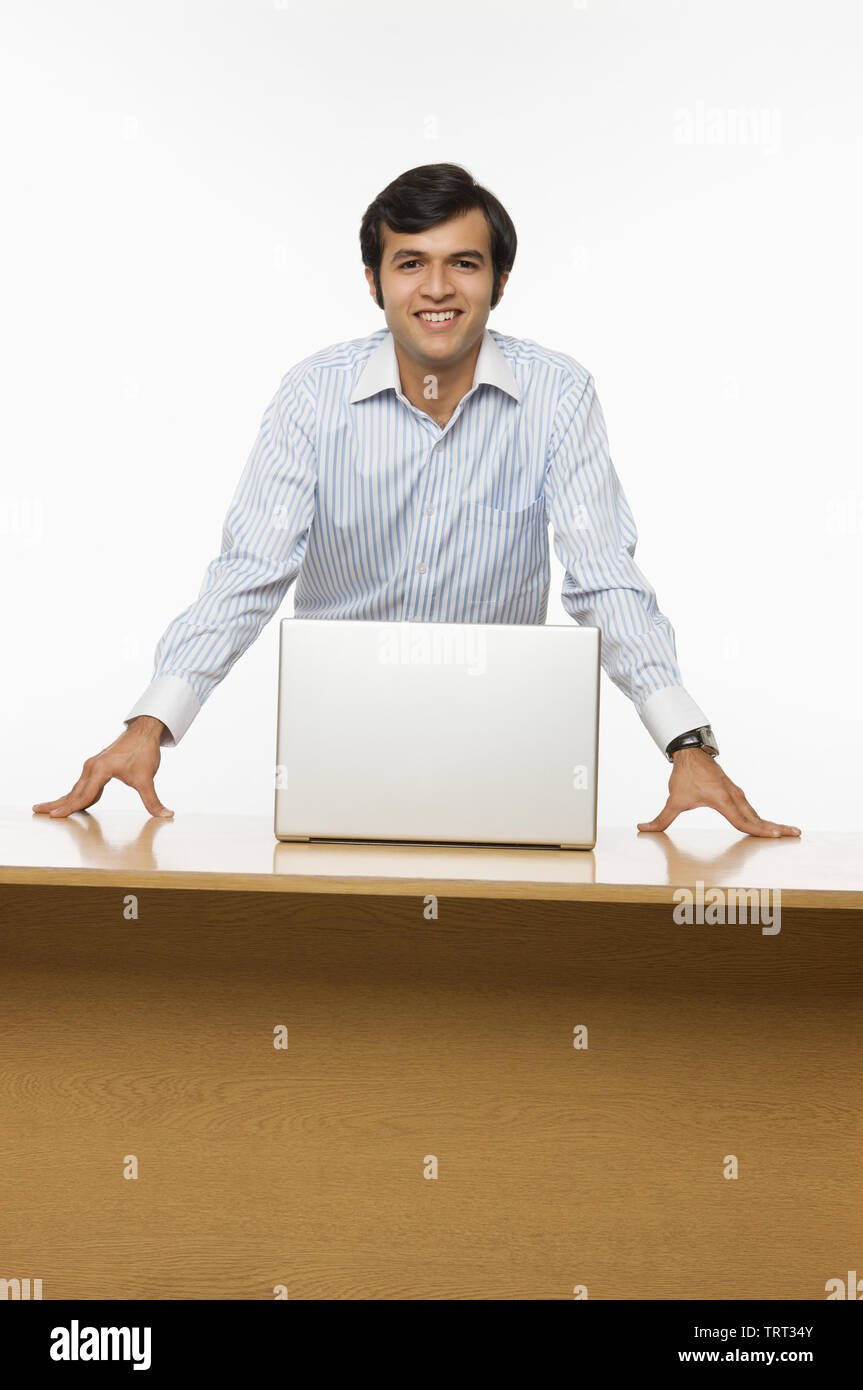 Professional man leaning against desk hi-res stock photography and ...