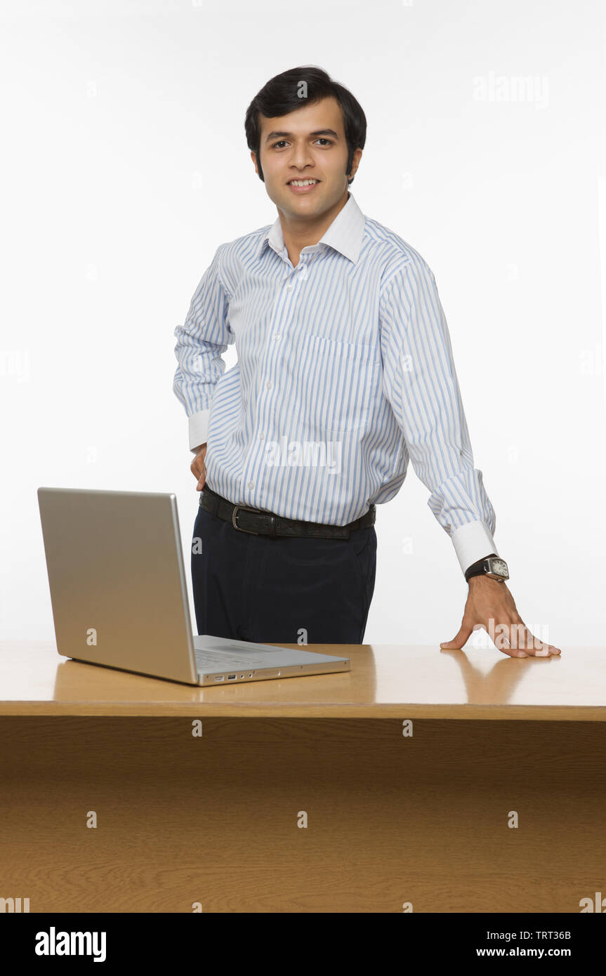 Businessman standing beside desk hi-res stock photography and images ...