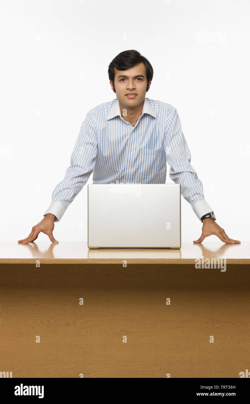 Professional man leaning against desk hi-res stock photography and ...