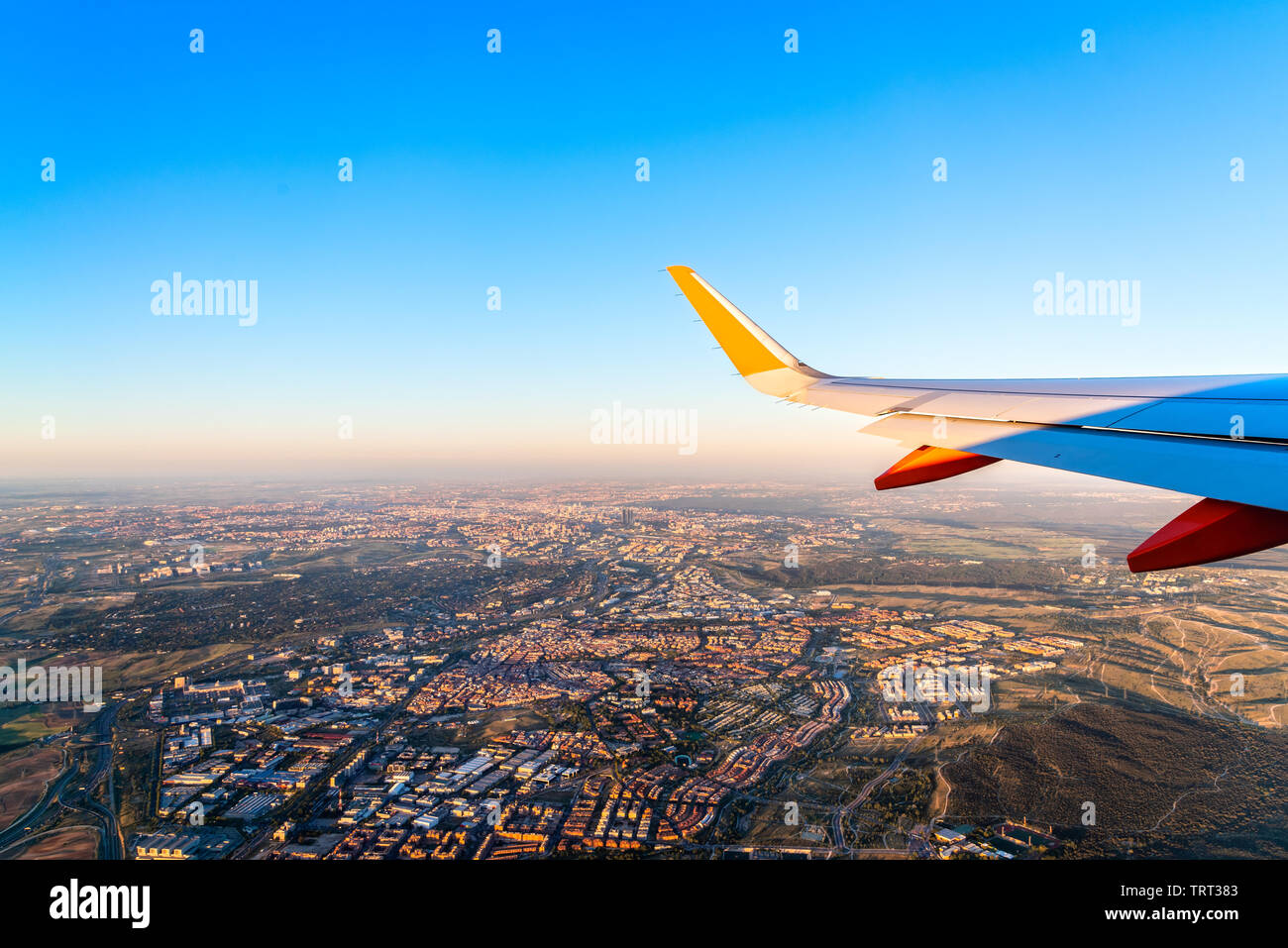 Wing of airplane flying over Madrid. Traveling concept Stock Photo - Alamy
