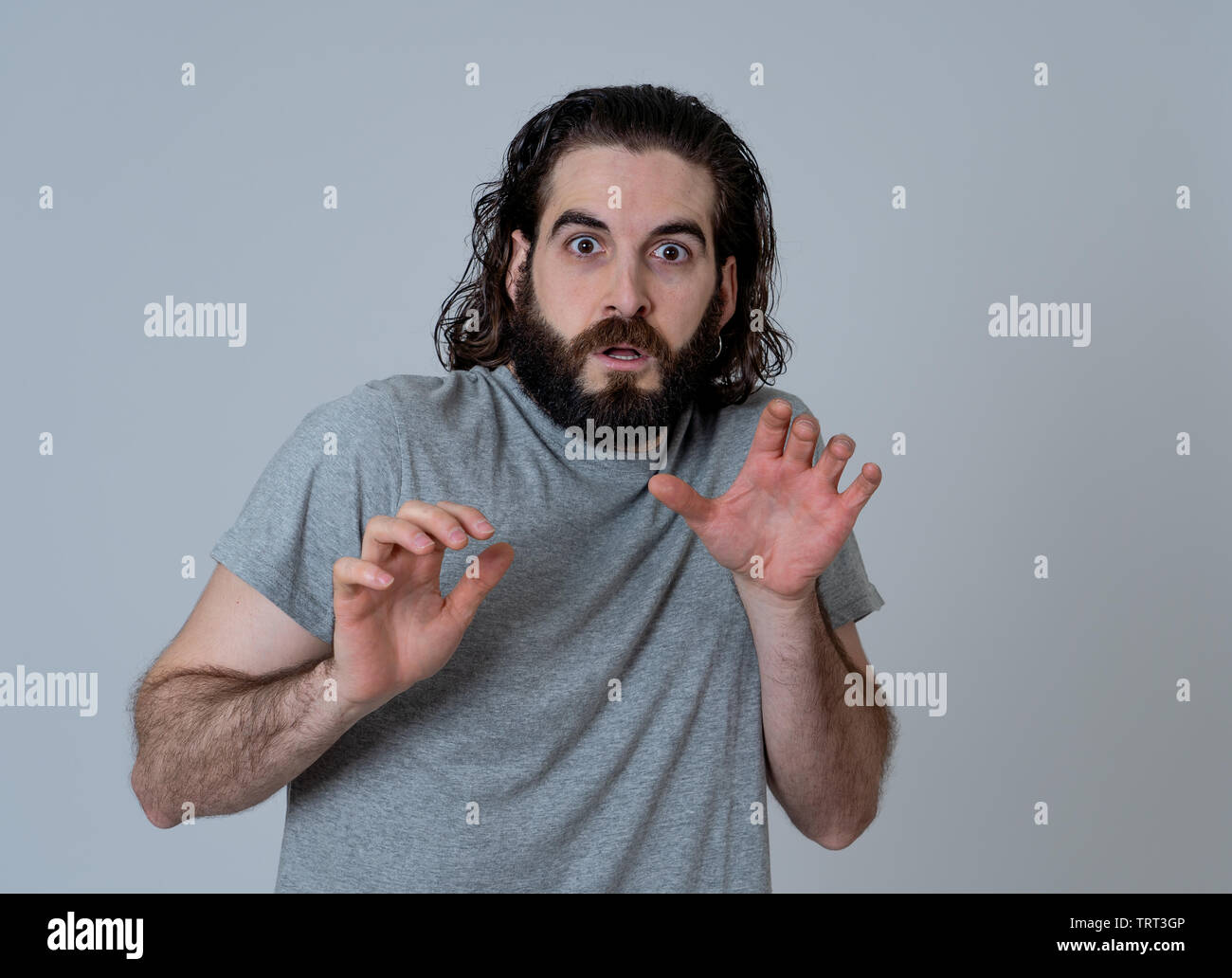 Portrait of young hipster man in shock with scared face making ...